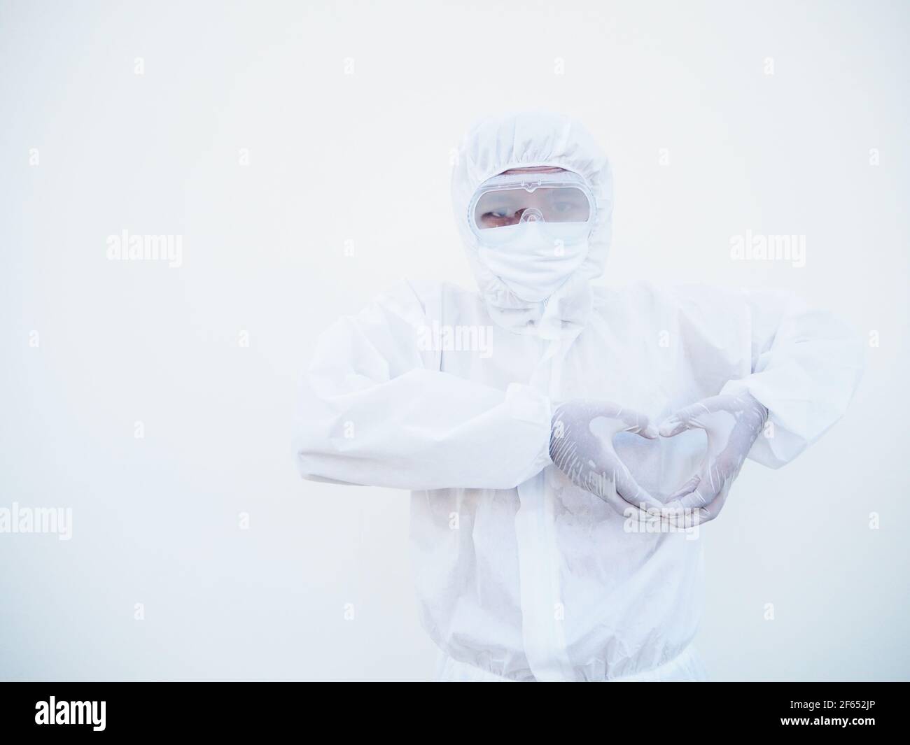 Doctor or scientist in PPE suite uniform showing love hand sign ...