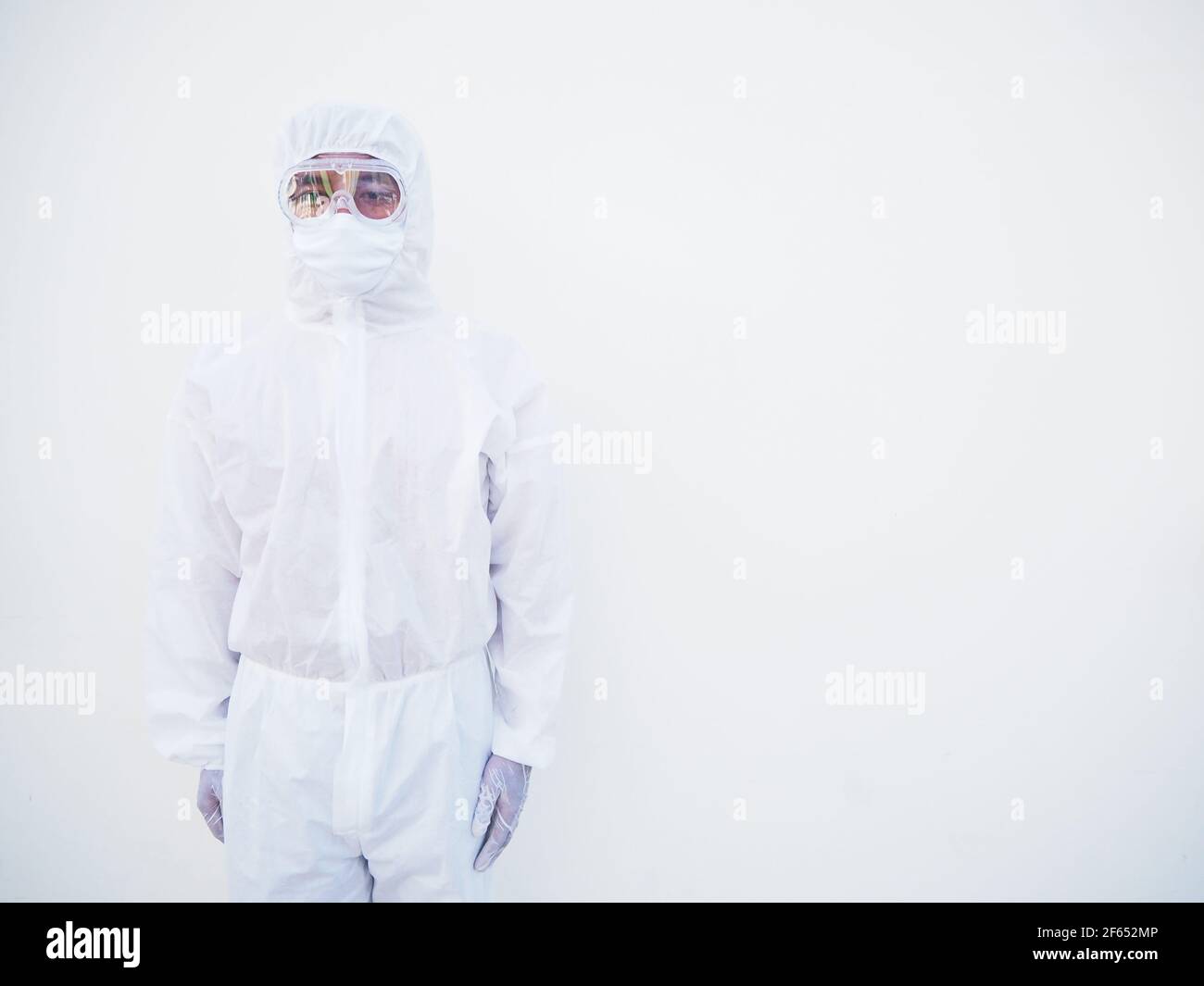 Confident asian male doctor or scientist in PPE suite uniform standing ...