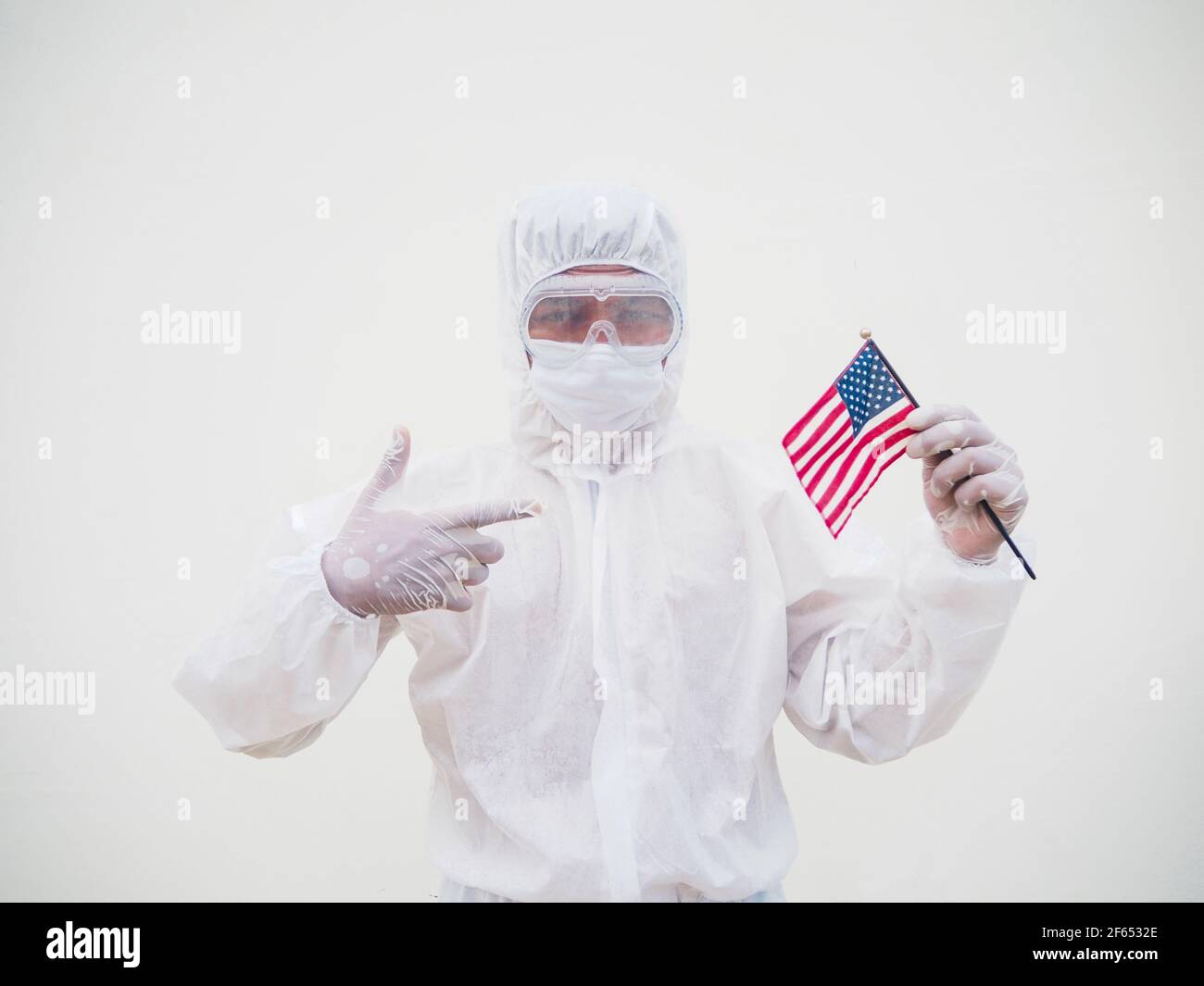 Portrait of doctor or scientist in PPE suite uniform holding national ...