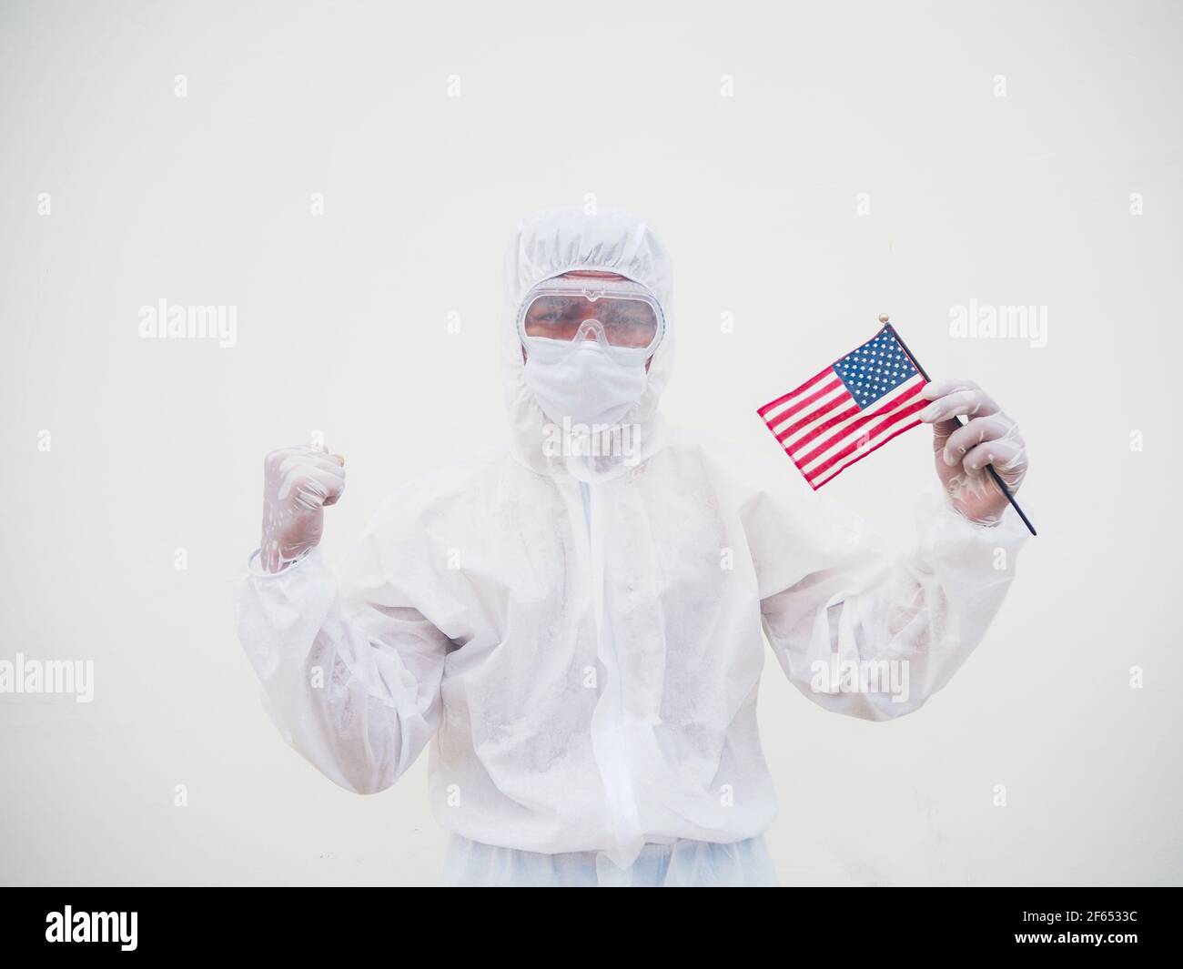 Portrait of doctor or scientist in PPE suite uniform holding national ...