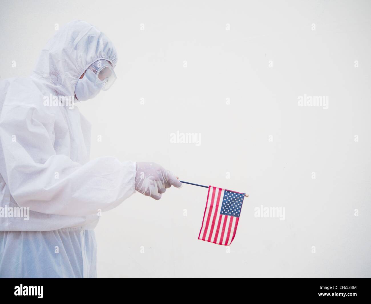 Portrait of doctor or scientist in PPE suite uniform holding national ...
