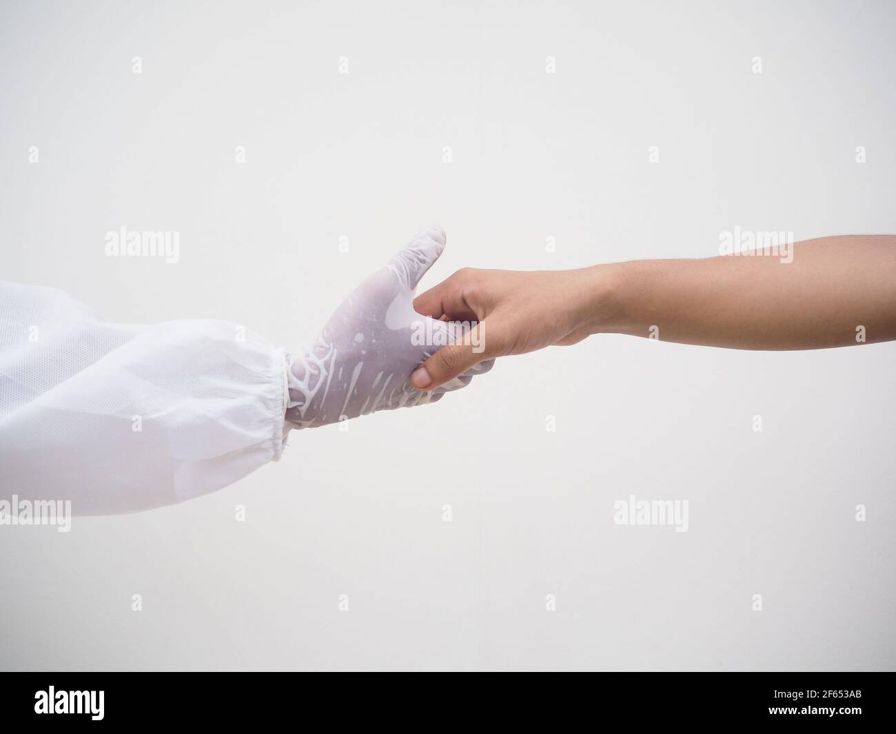 Closeup shank hand protected contact between doctor or scientist in PPE ...