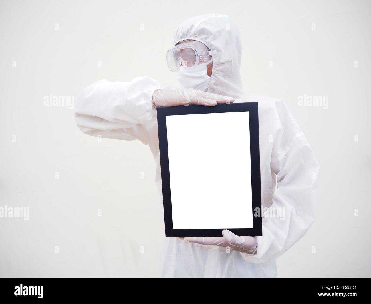 Asian doctor or scientist in PPE suite uniform. holding white screen ...