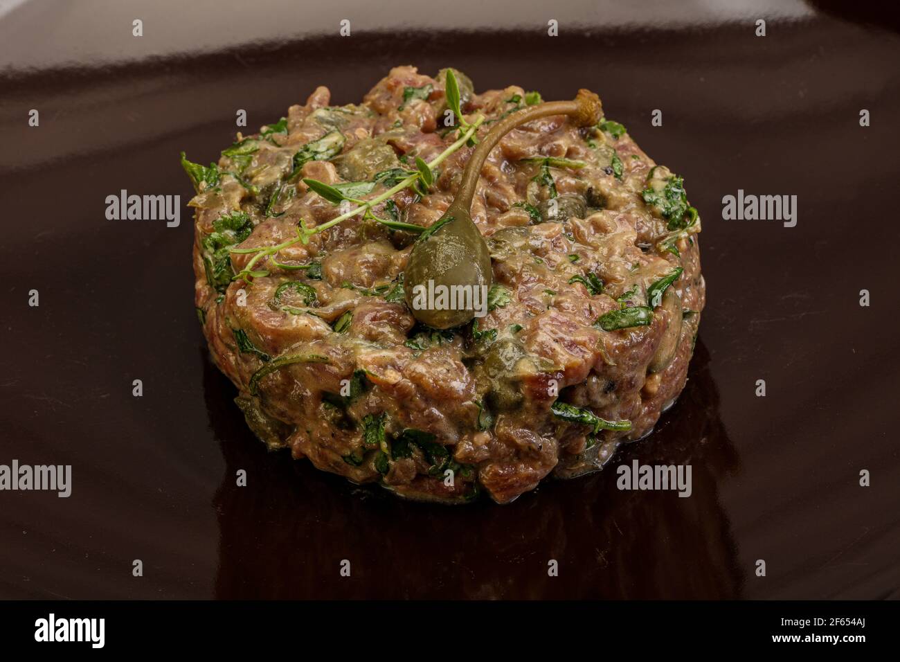 Raw beef tartar snack with capers Stock Photo - Alamy