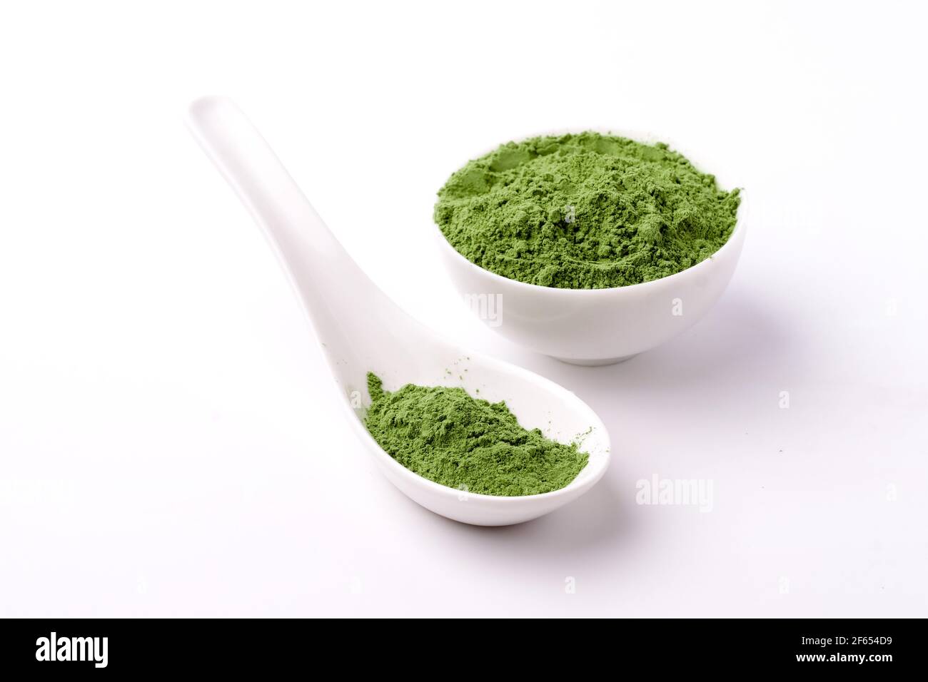 Green Barley Sprout grass and bowl of green detox powder isolated on ...