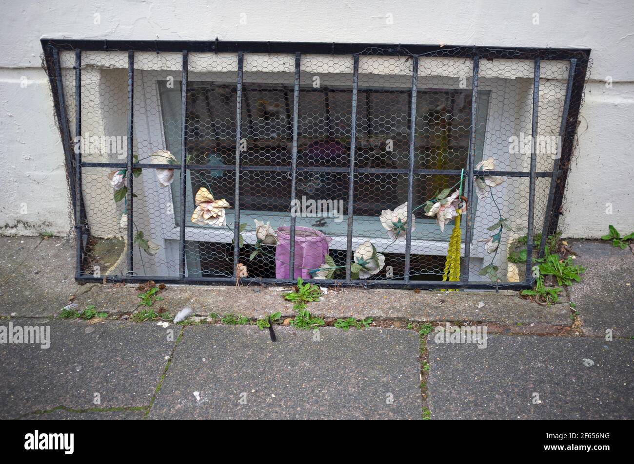 A basement window in a Brighton street Stock Photo - Alamy