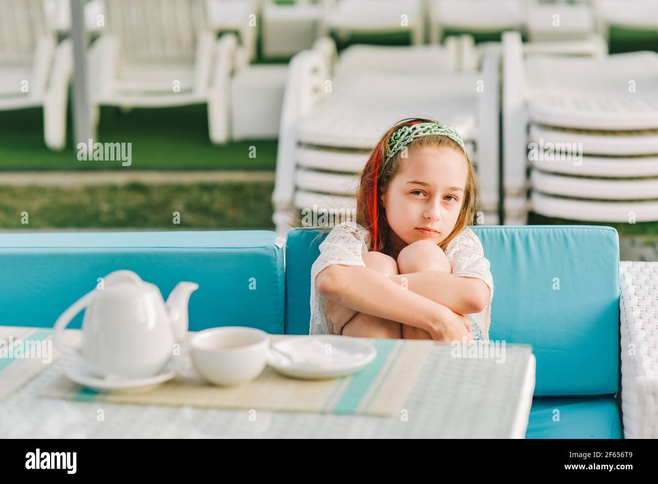 Teenage girl is drinking tea. Teenage girl in a summer cafe. Summer ...