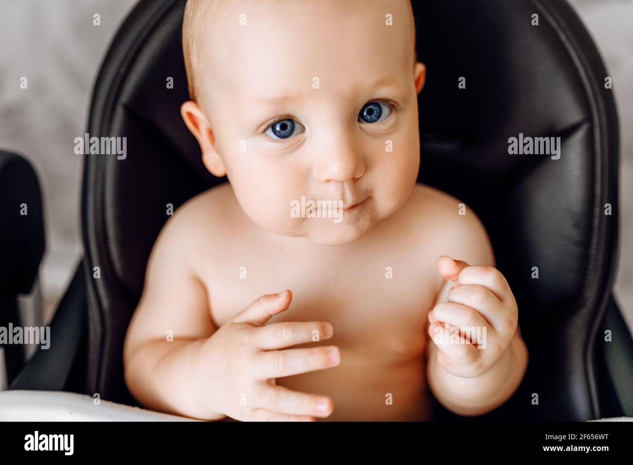 Happy child sitting in a baby chair, baby food concept Stock Photo - Alamy