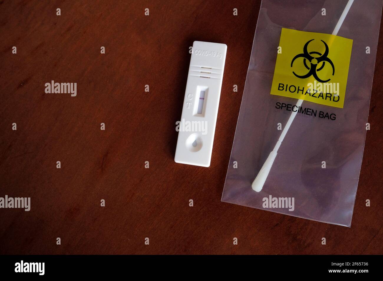 Coronavirus (COVID-19) rapid test with negative result next to a nasal ...