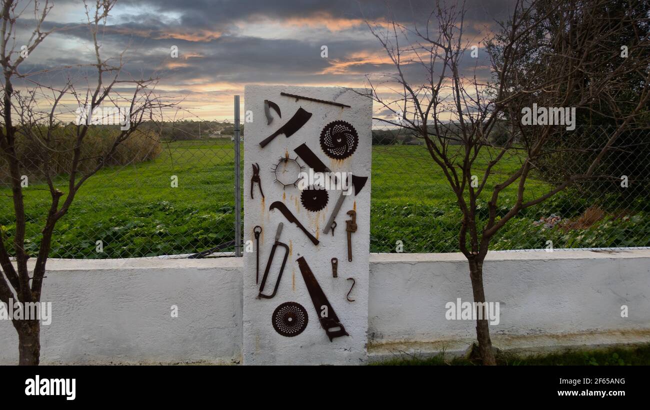 Old Power tools hanging on the white wall Stock Photo - Alamy