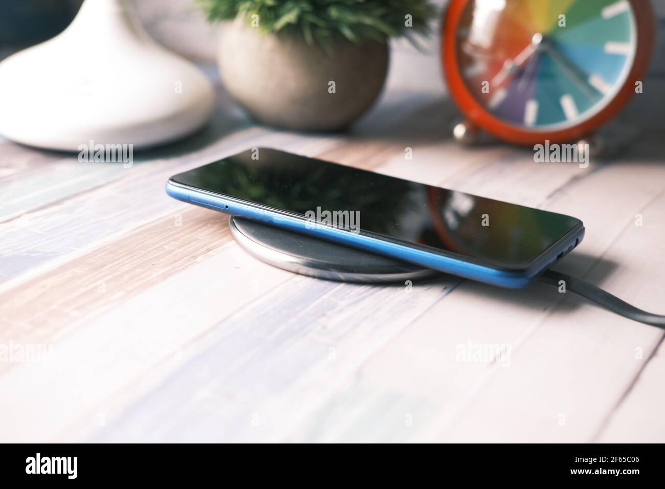 charging Smartphone using Wireless Charging Pad, top view Stock Photo ...