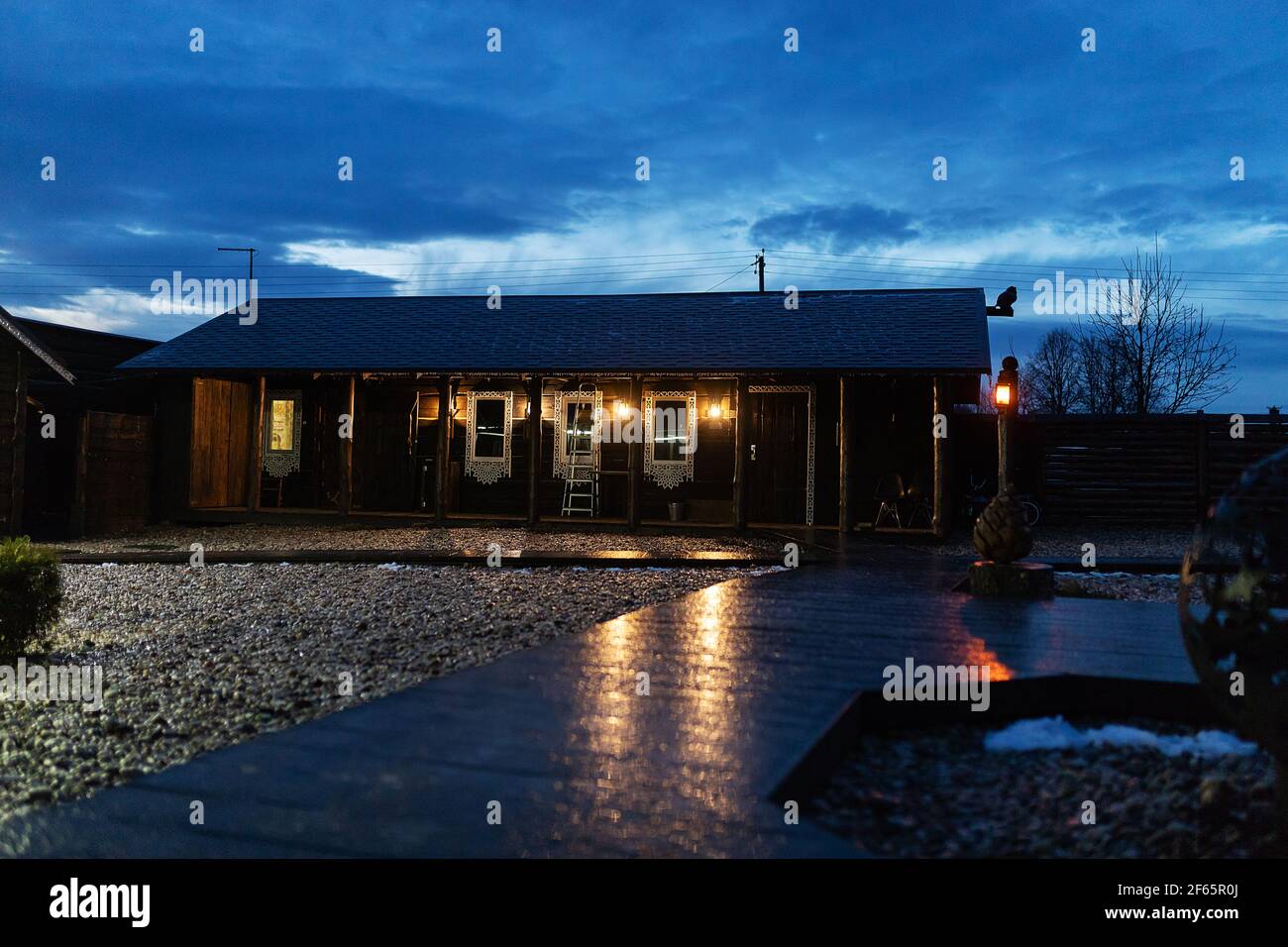 beautiful wooden hut. night illumination from lanterns illuminates the ...