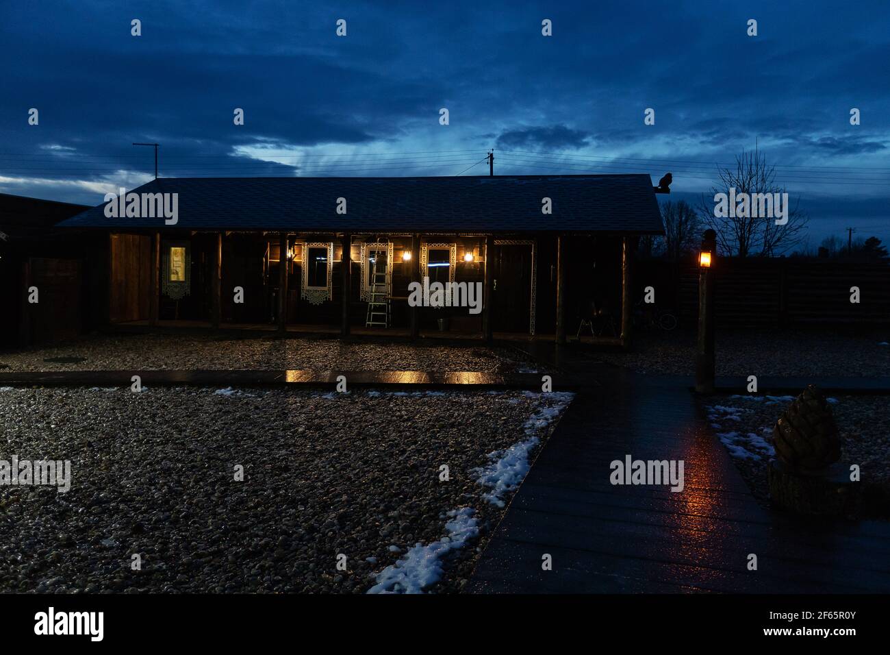 beautiful wooden hut. night illumination from lanterns illuminates the ...