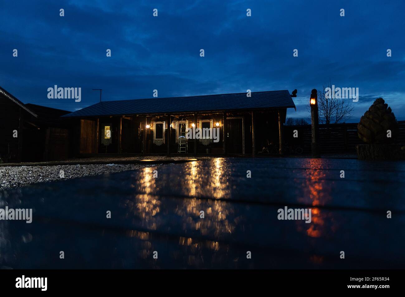 beautiful wooden hut. night illumination from lanterns illuminates the ...