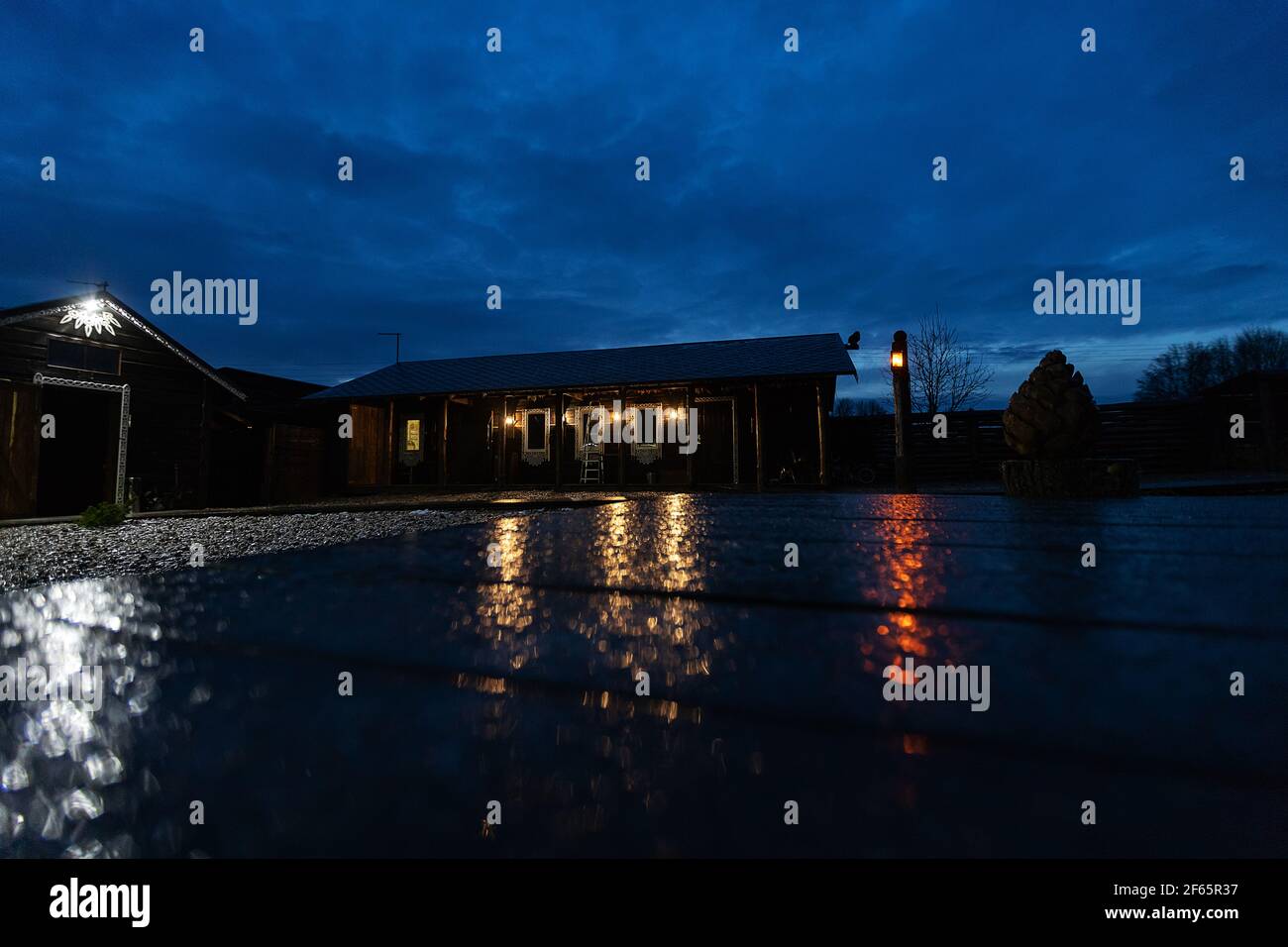 beautiful wooden hut. night illumination from lanterns illuminates the ...