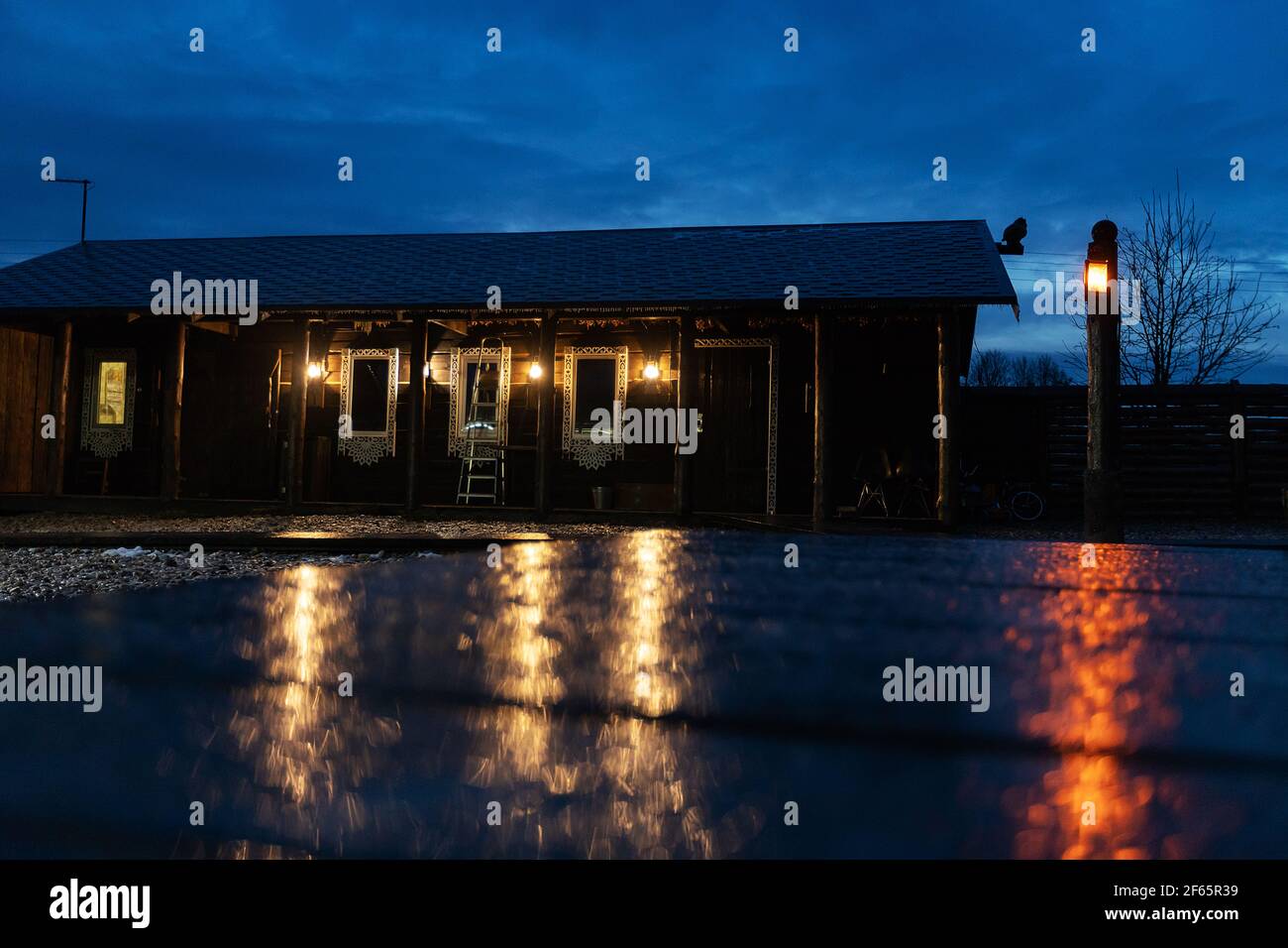 beautiful wooden hut. night illumination from lanterns illuminates the ...