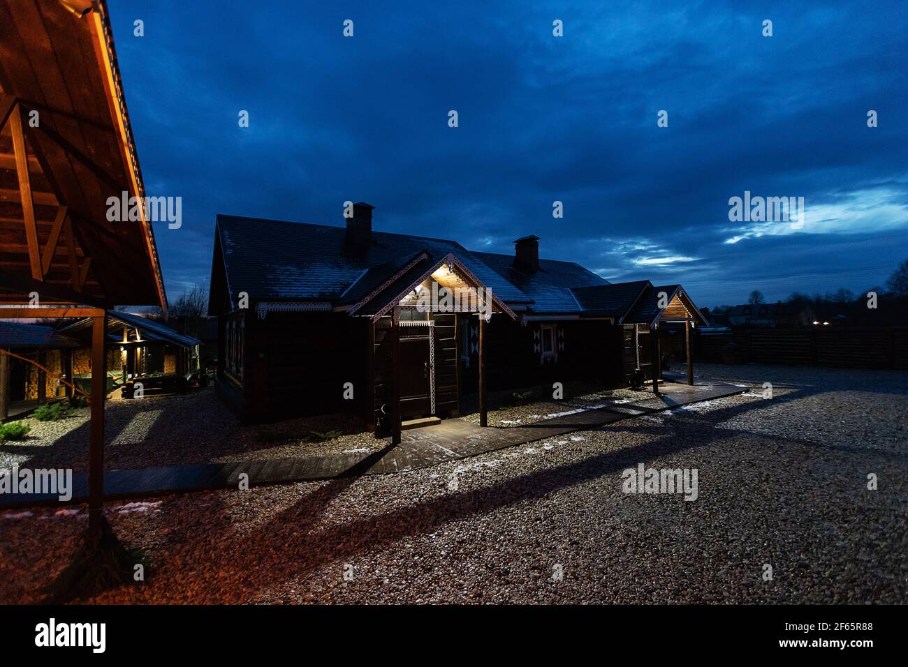 beautiful wooden hut. night illumination from lanterns illuminates the ...