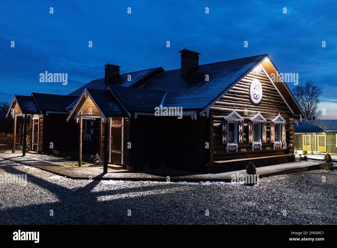beautiful wooden hut. night illumination from lanterns illuminates the ...