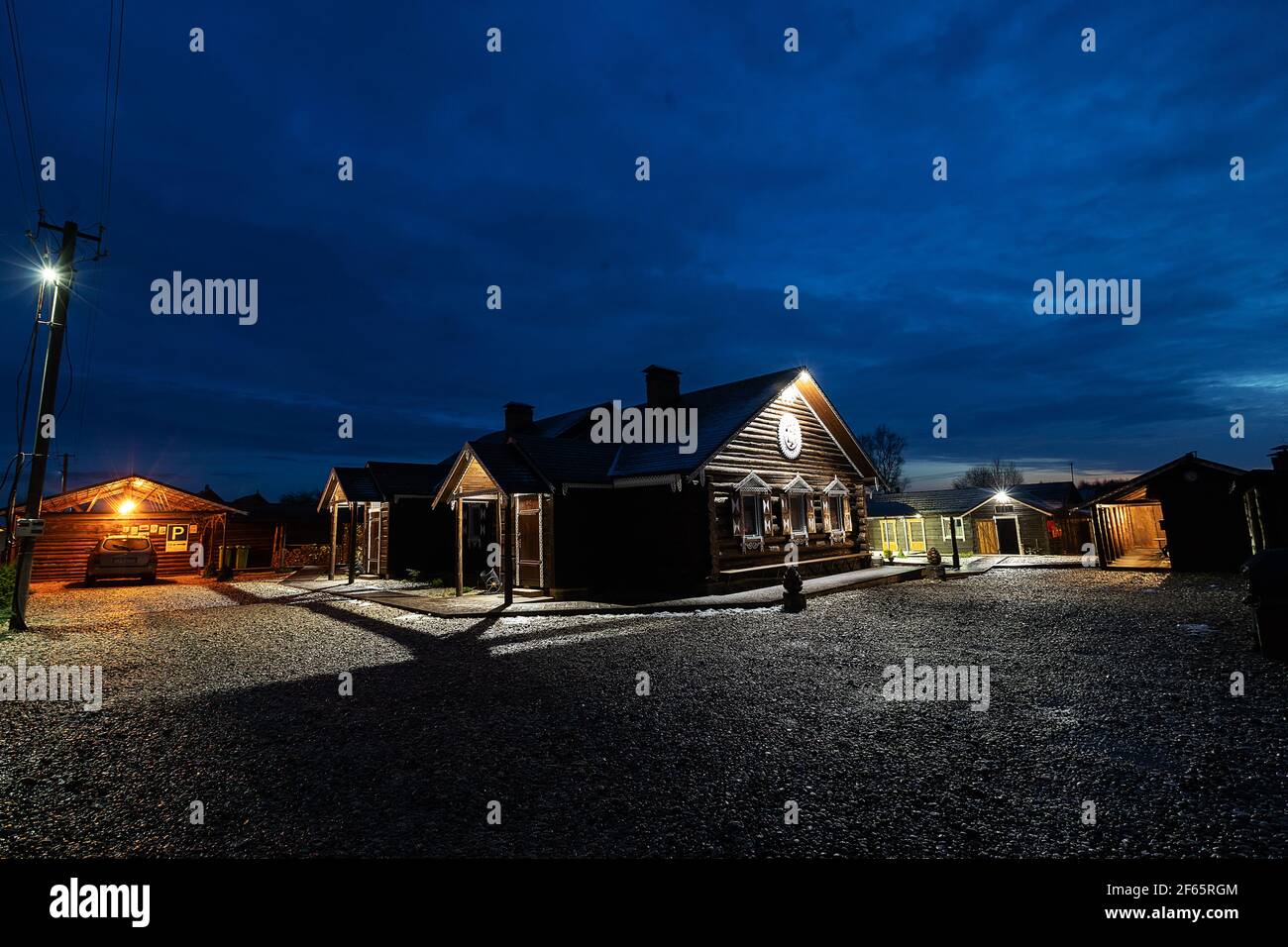 beautiful wooden hut. night illumination from lanterns illuminates the ...
