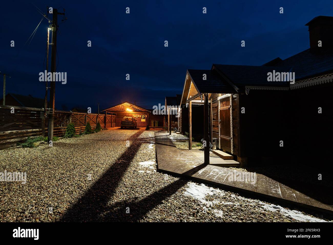 beautiful wooden hut. night illumination from lanterns illuminates the ...