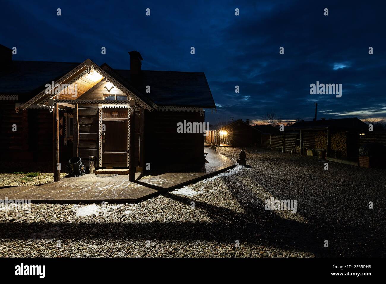 beautiful wooden hut. night illumination from lanterns illuminates the ...