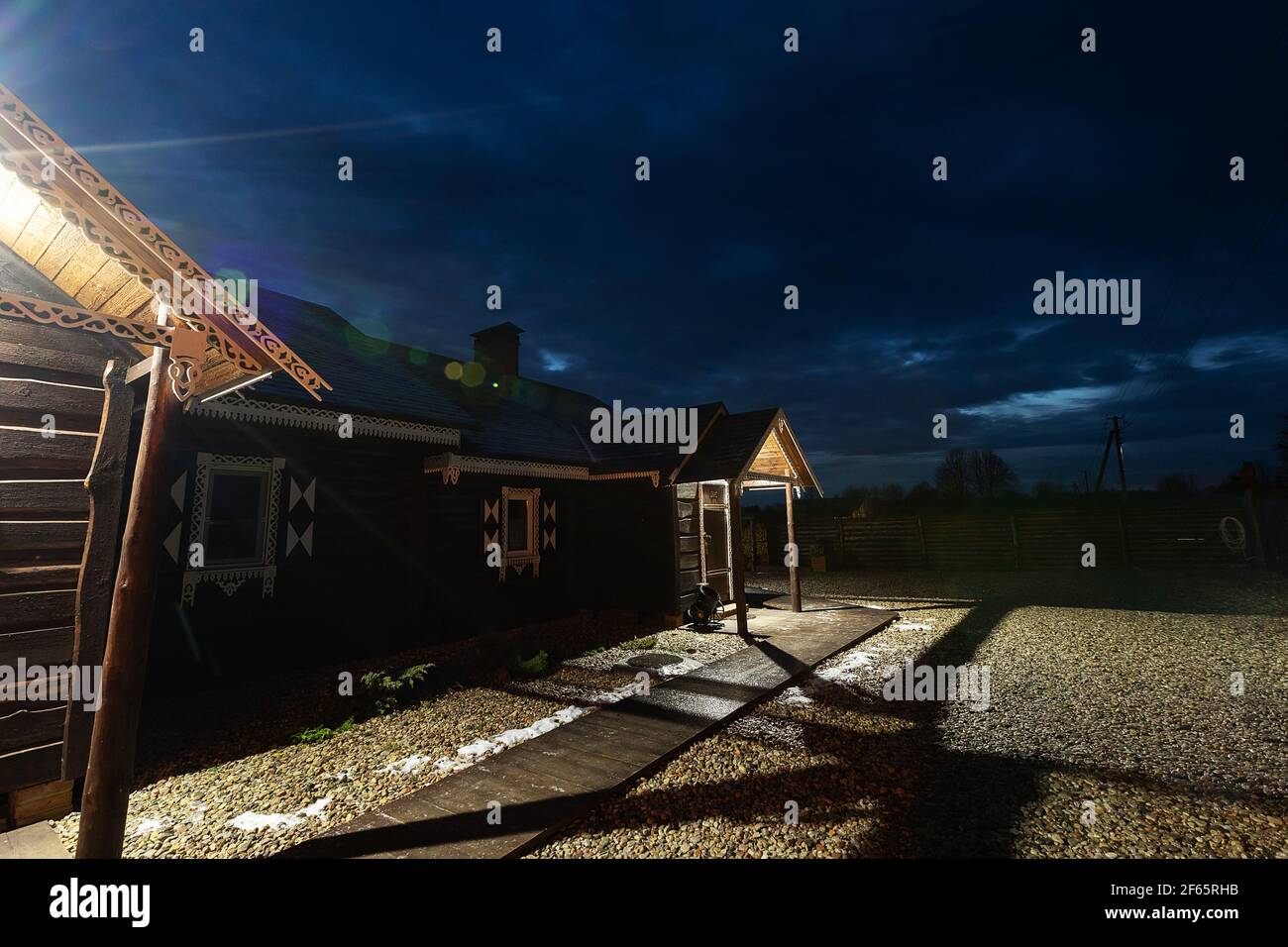 beautiful wooden hut. night illumination from lanterns illuminates the ...