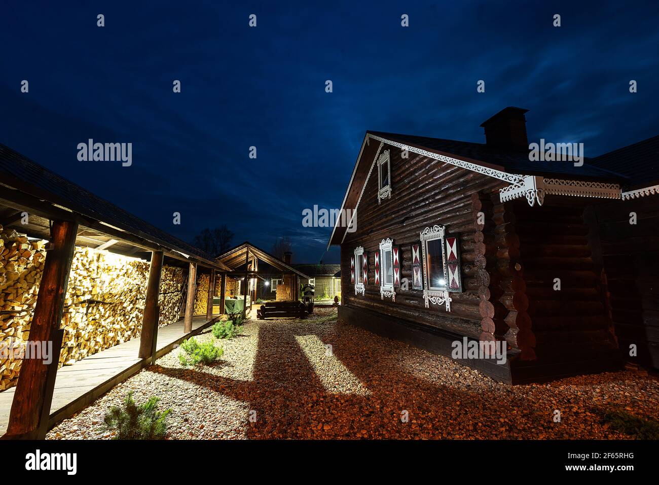 beautiful wooden hut. night illumination from lanterns illuminates the ...
