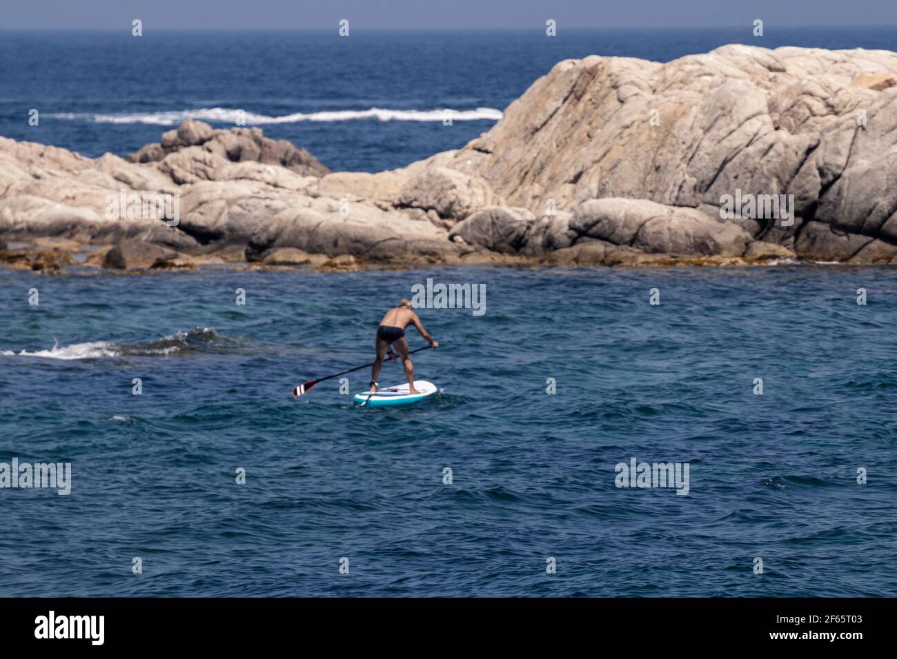 people paddle surfing on the costa brava in girona on a summer day in a ...