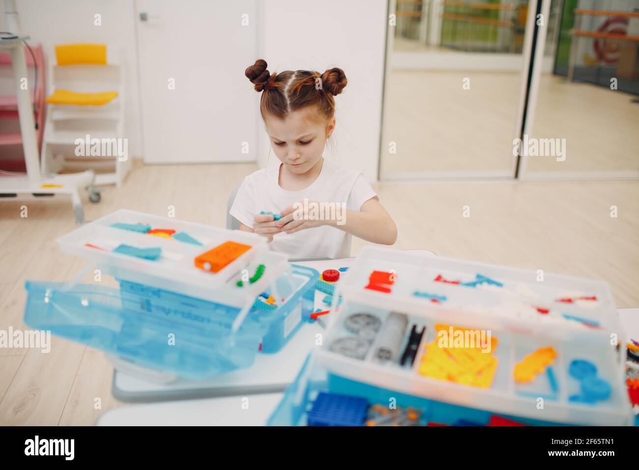Smiling kid child constructor checking technical toy. Children Robotics ...