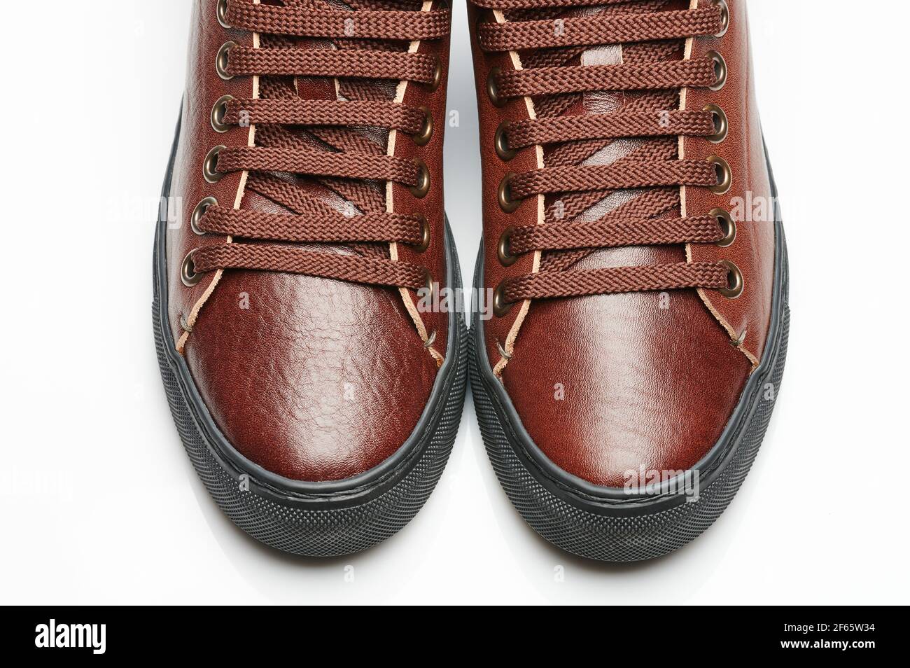 Close up of brown leather shoes toes isolated on white studio ...