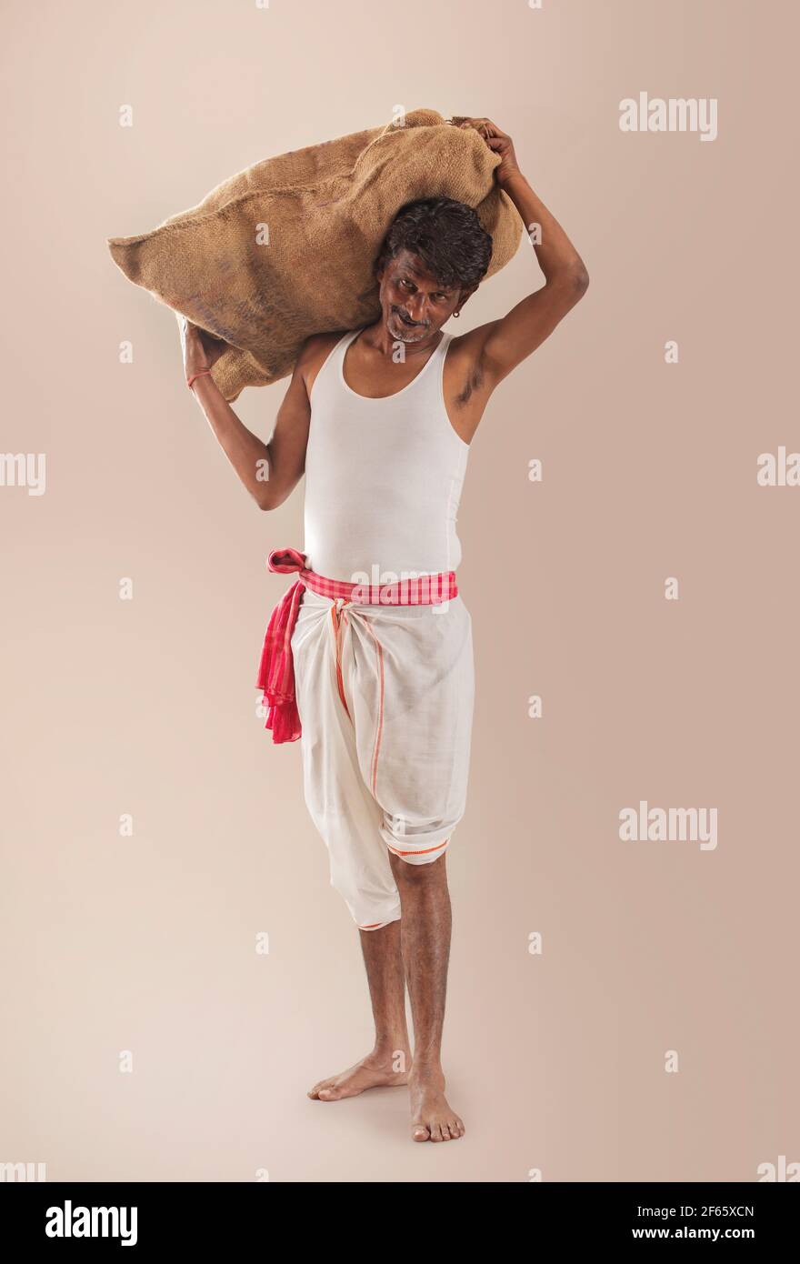 Indian man carrying sack hi-res stock photography and images - Alamy