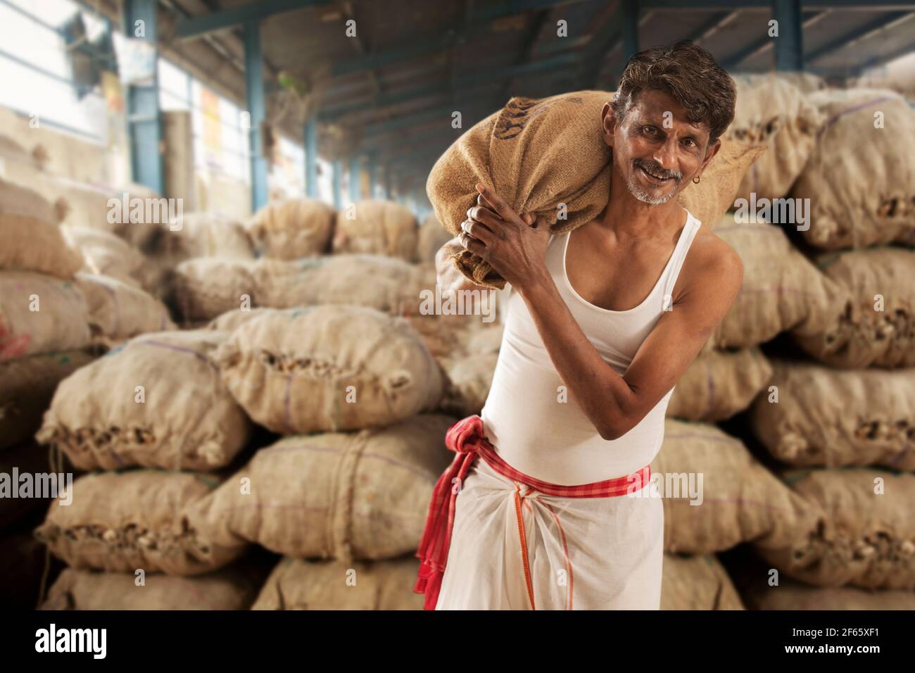 Indian man carrying sack hi-res stock photography and images - Alamy