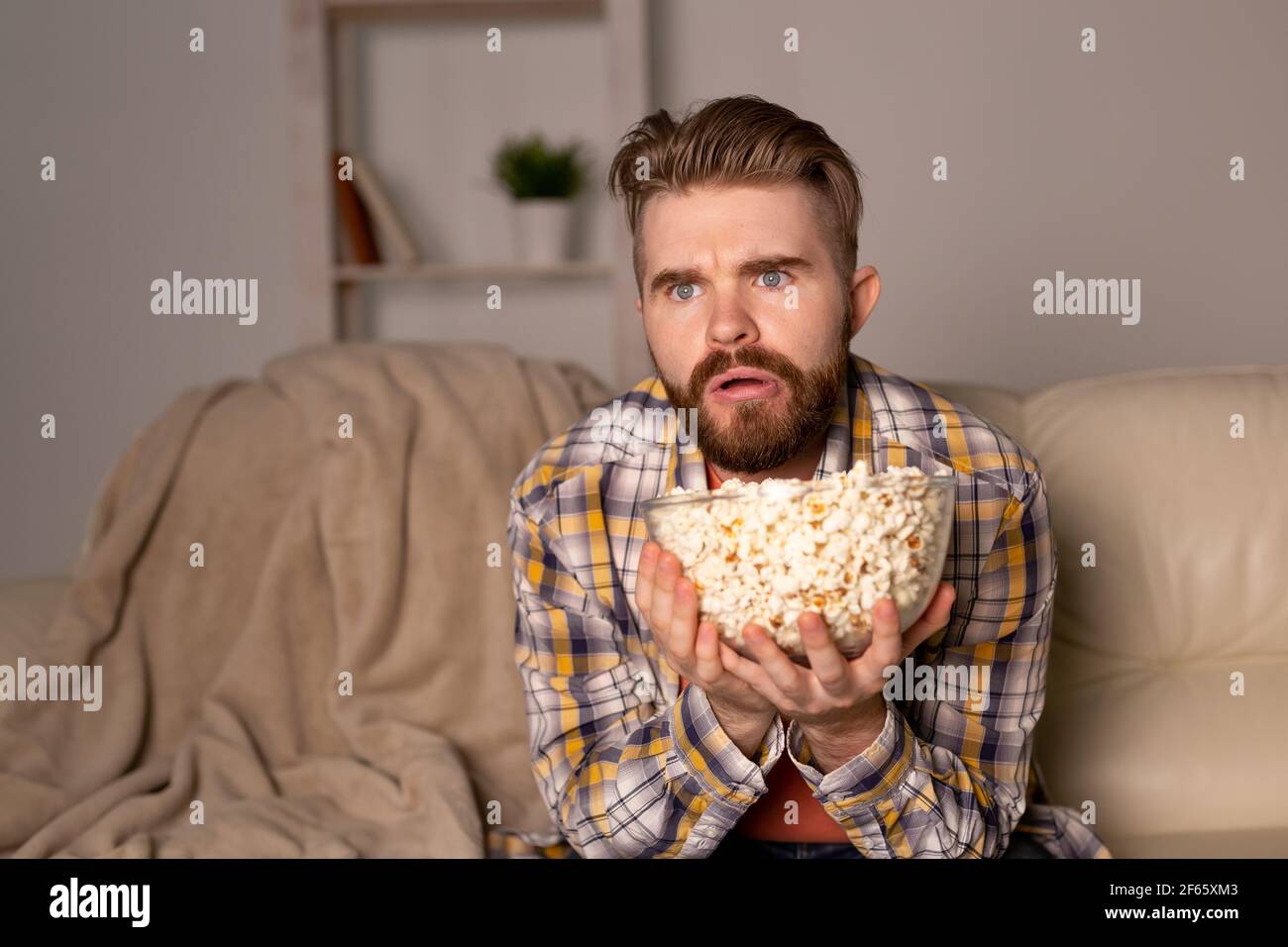 Single man on the couch watching TV Stock Photo - Alamy