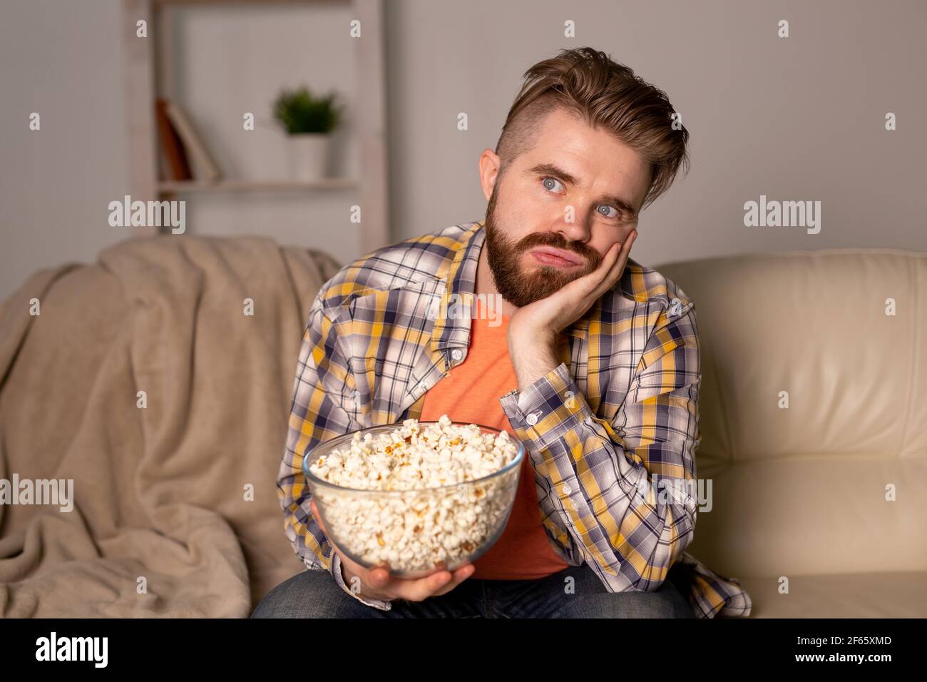 Single man on the couch watching TV Stock Photo - Alamy