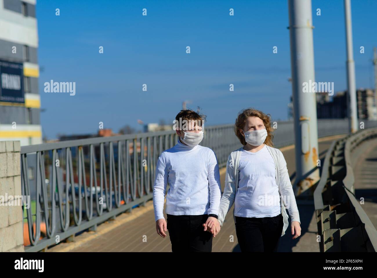 Little sister and brother in casual clothes and protective masks ready ...
