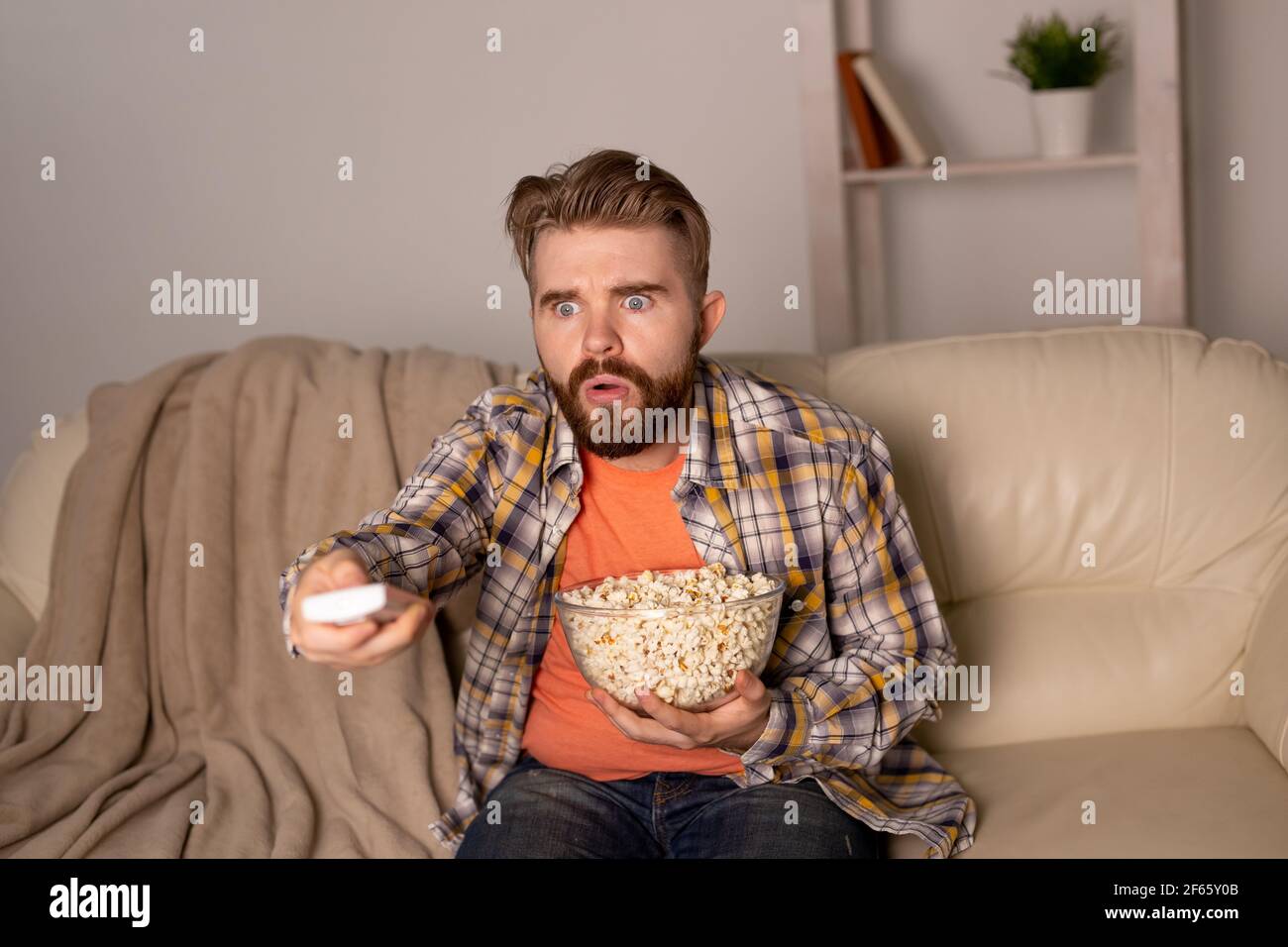 Single man on the couch watching TV Stock Photo - Alamy