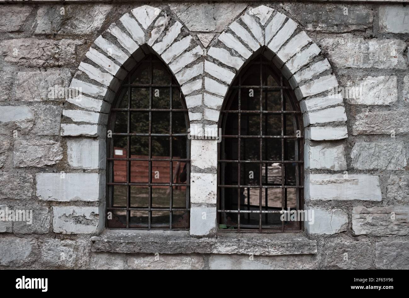 A mullioned window with pointed arches in a medieval stone building ...