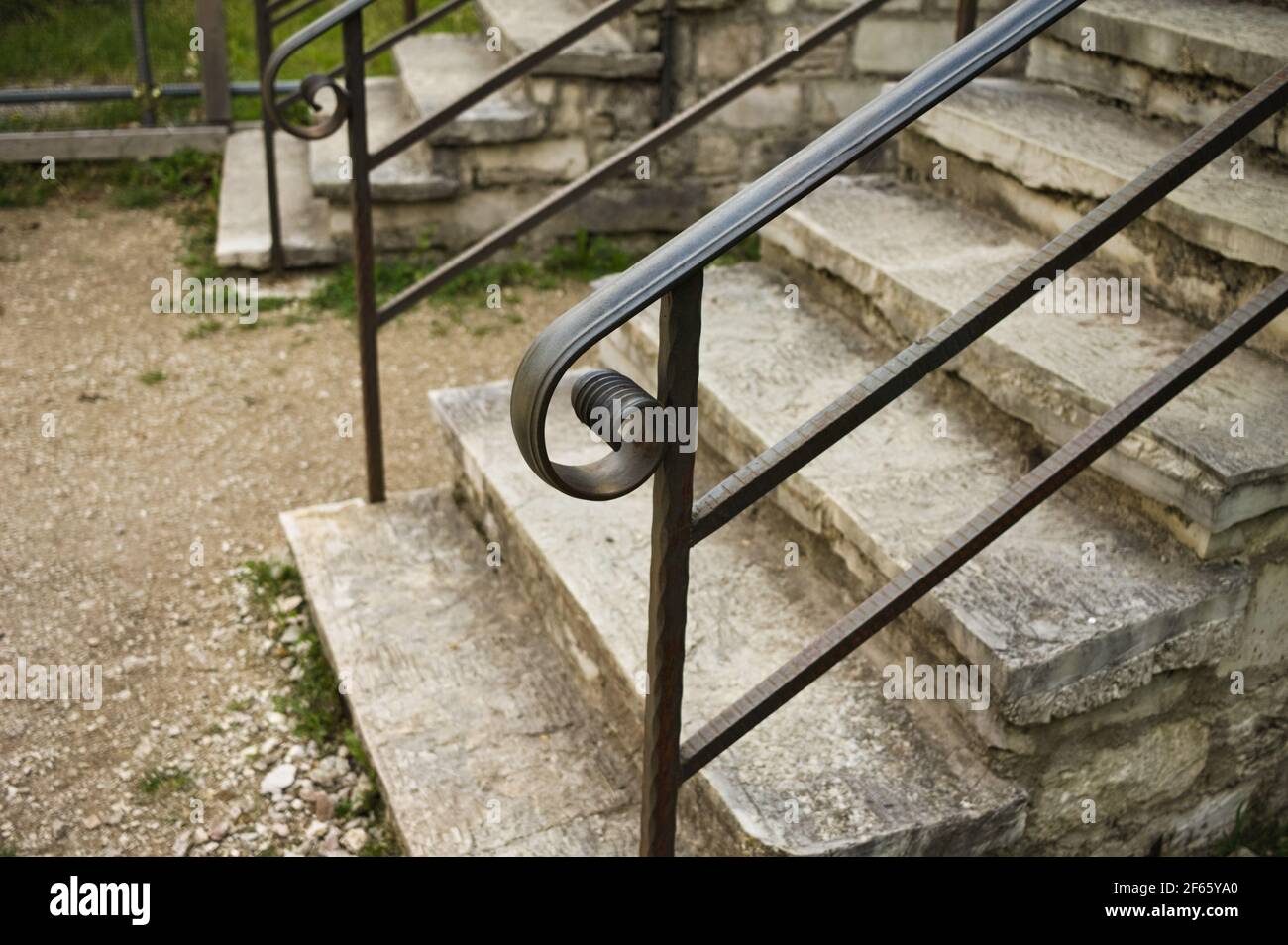 Decorative wrought iron handrail on external stone stairs (Marche ...