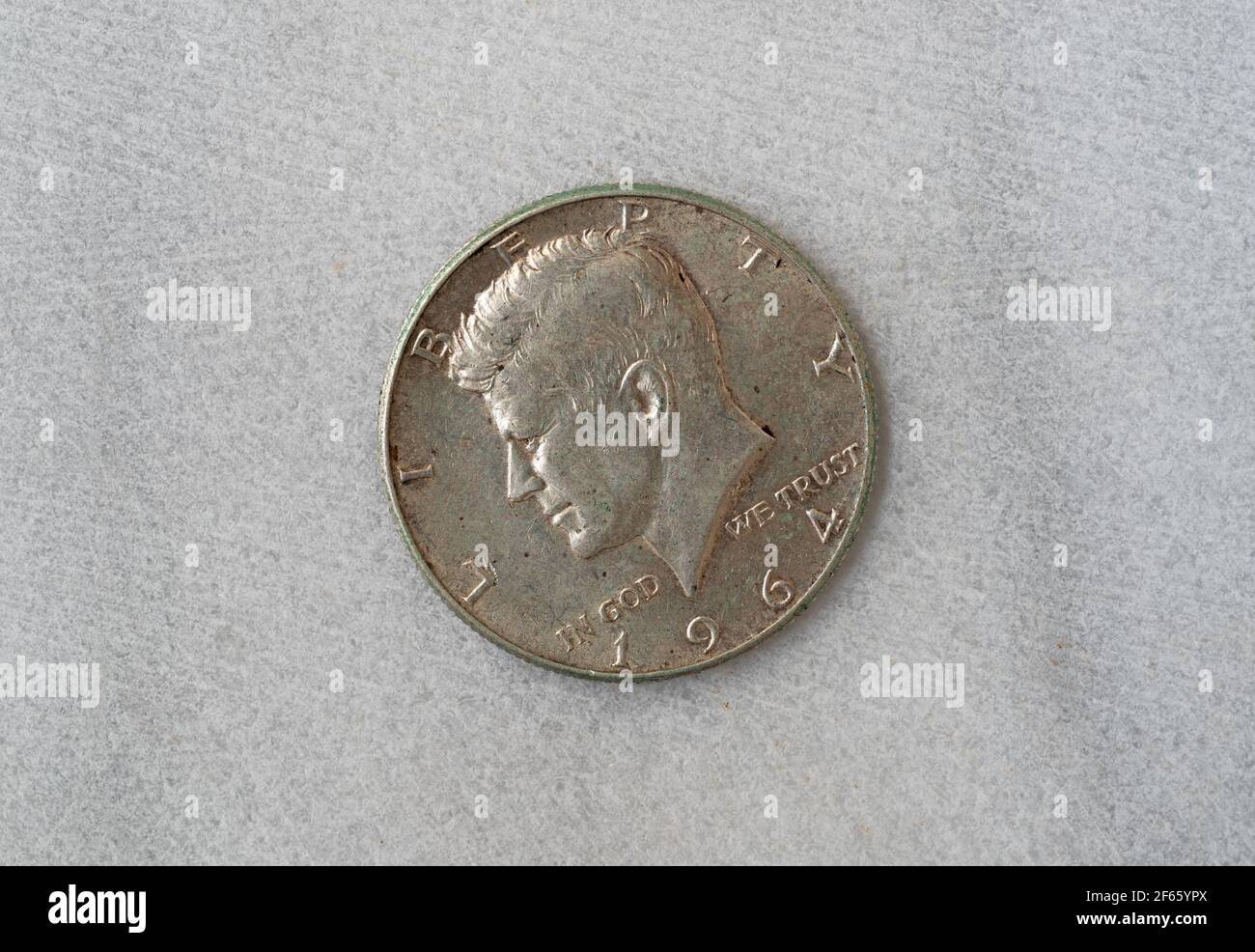 Single Kennedy silver half dollar American coin on a marble surface ...