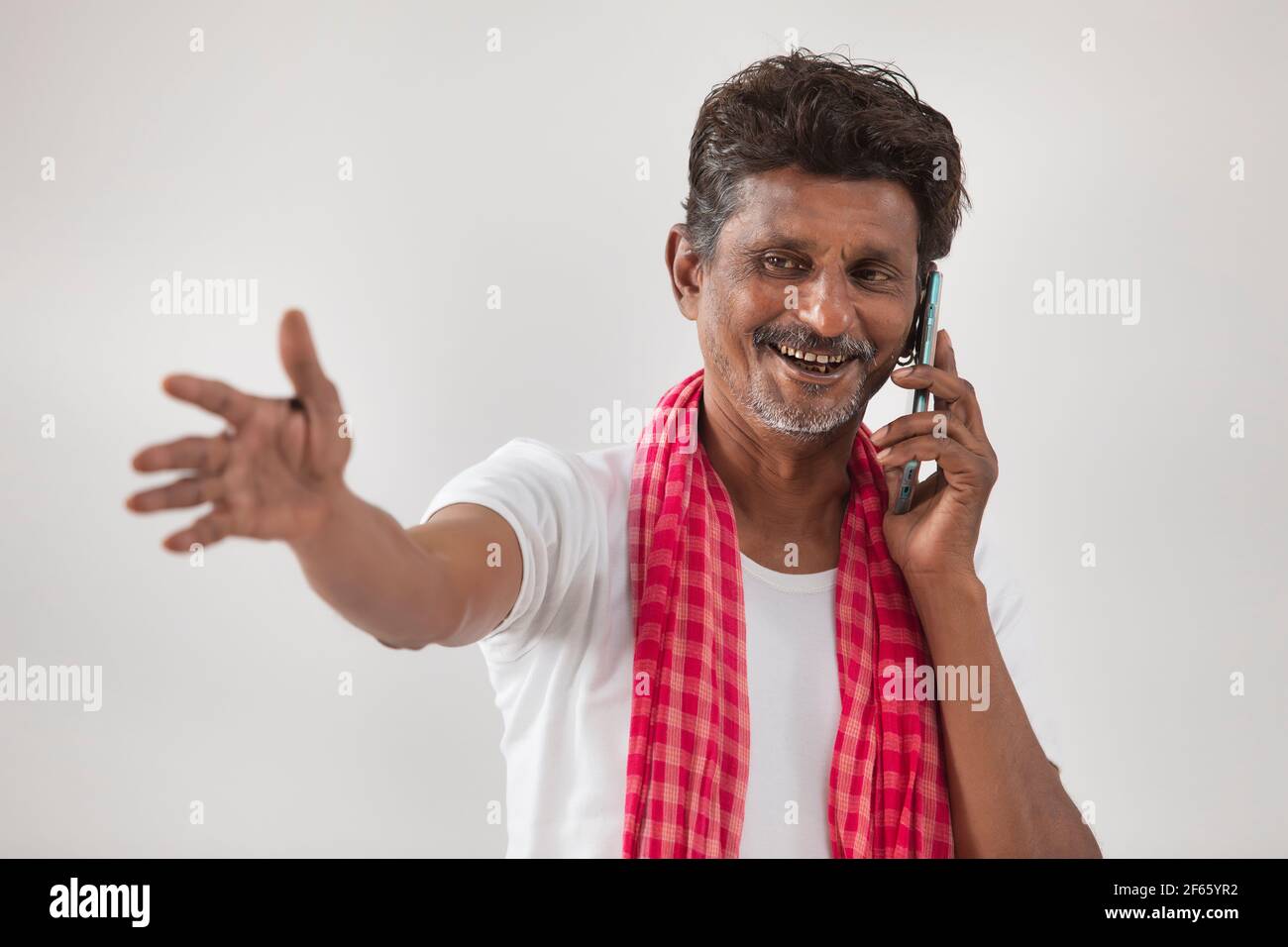 PORTRAIT OF A RURAL MAN TALKING OVER MOBILE PHONE AND SMILING Stock ...