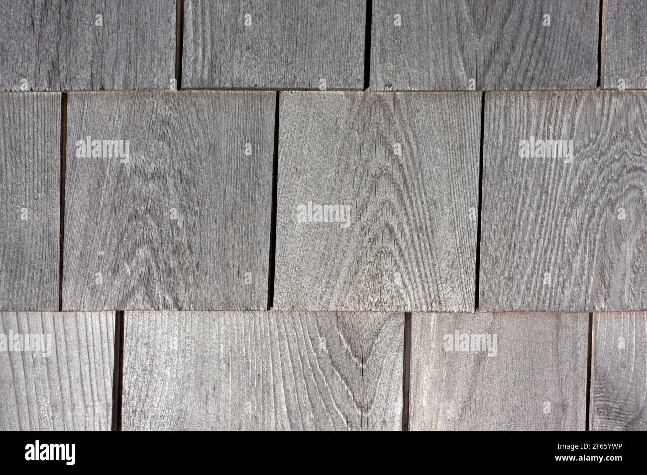 Close view of rows of unsealed wood shingles that have grayed with sun ...