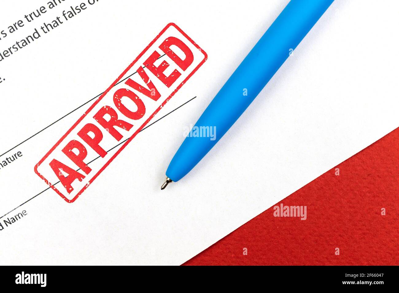 Document with approved stamp on it, businessman's office desk and ...