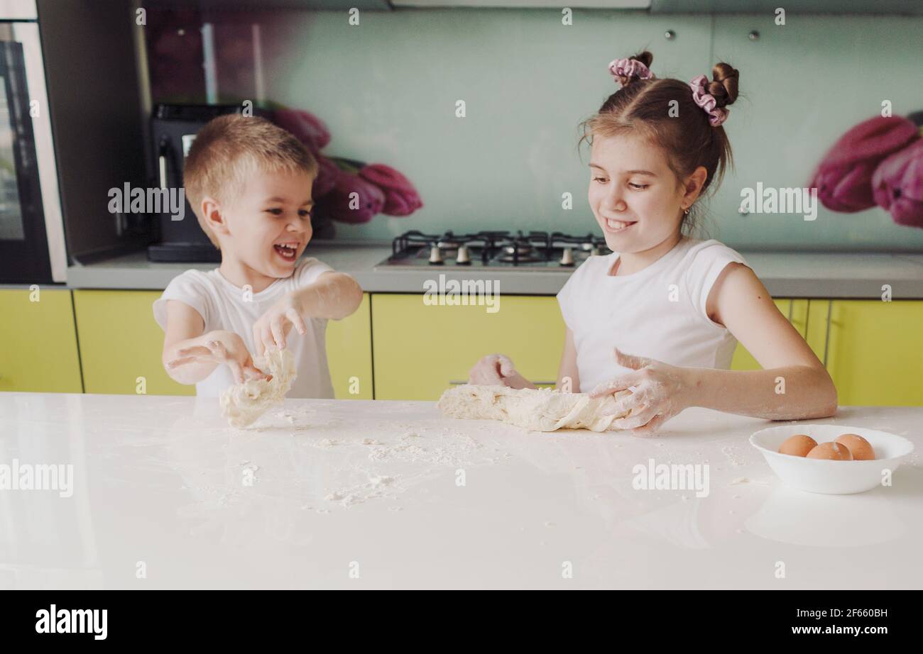 Beautiful Young Brother And Sister Messing Around With Dough In The