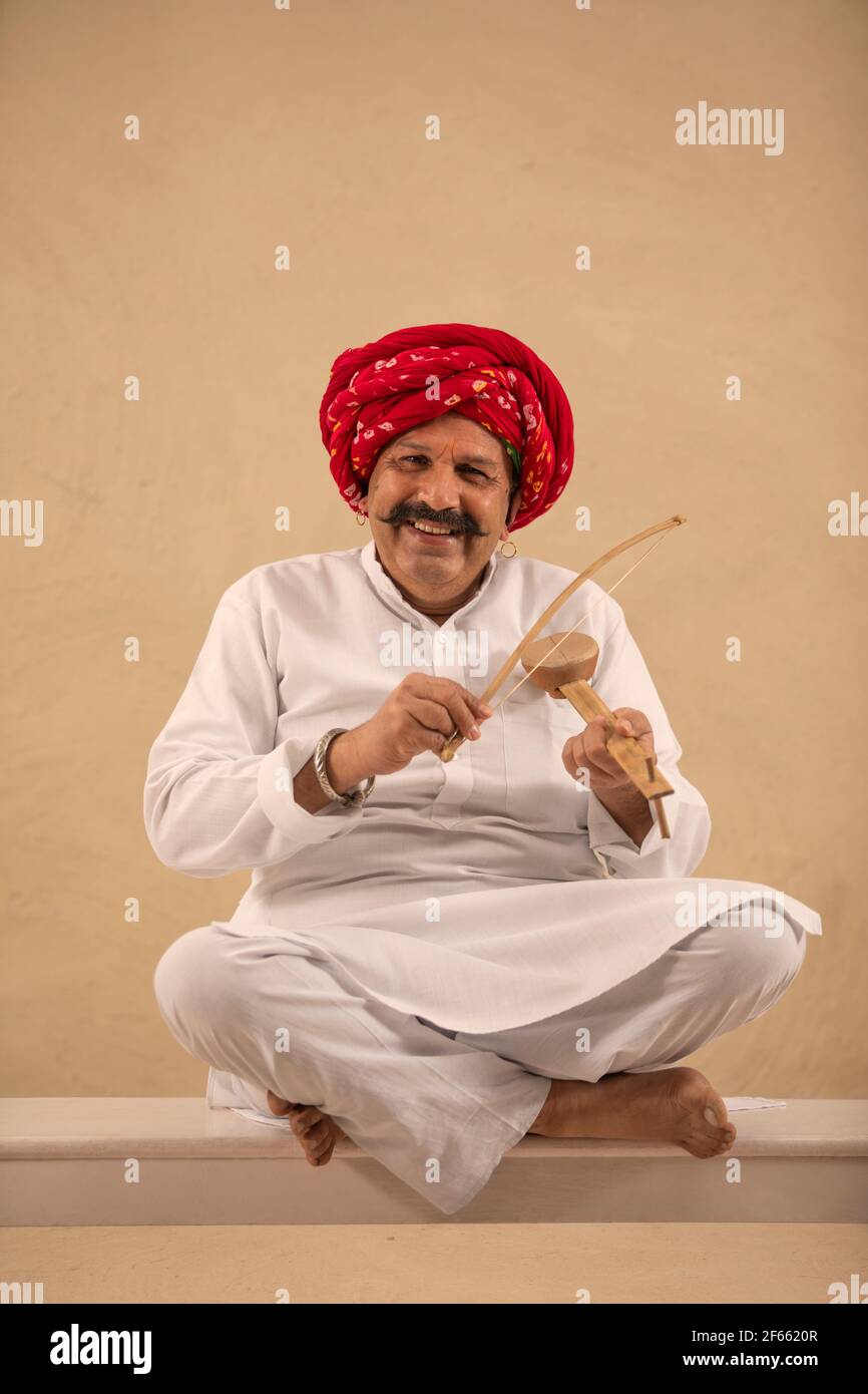 Man male turban music instrument hi-res stock photography and images ...