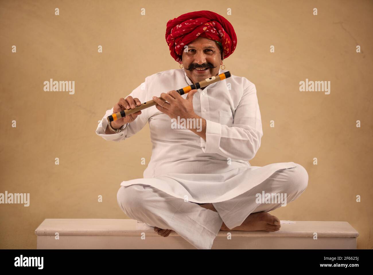 A HAPPY TURBANED MAN SITTING WITH HIS FLUTE TO PLAY Stock Photo - Alamy