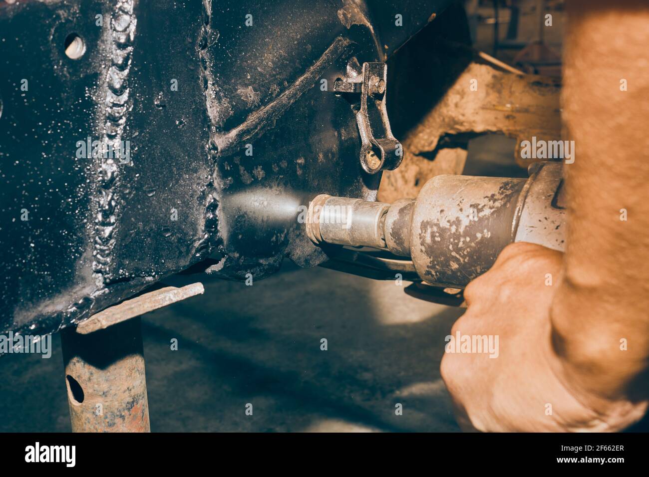 Car Mechanic or Auto Mechanic Tighten Nut of Car Leaf Spring by Wind ...