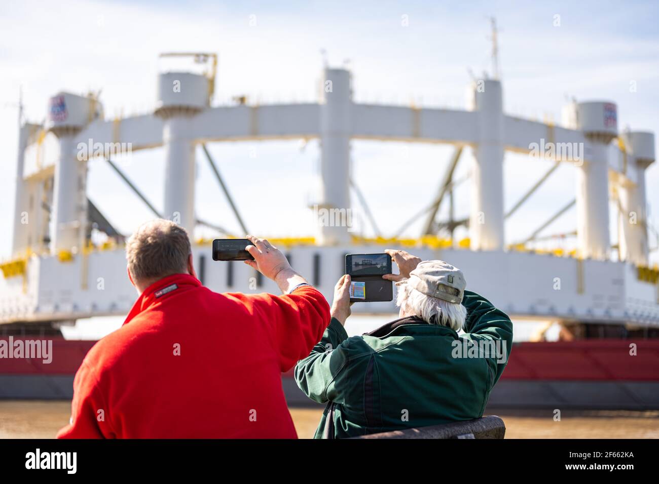 Emden, Germany. 30th Mar, 2021. Two men take pictures of how the 1,600 ...