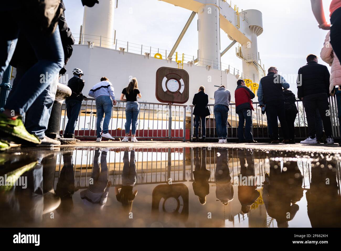 Emden, Germany. 30th Mar, 2021. Onlookers watch as the 1,600-tonne ...