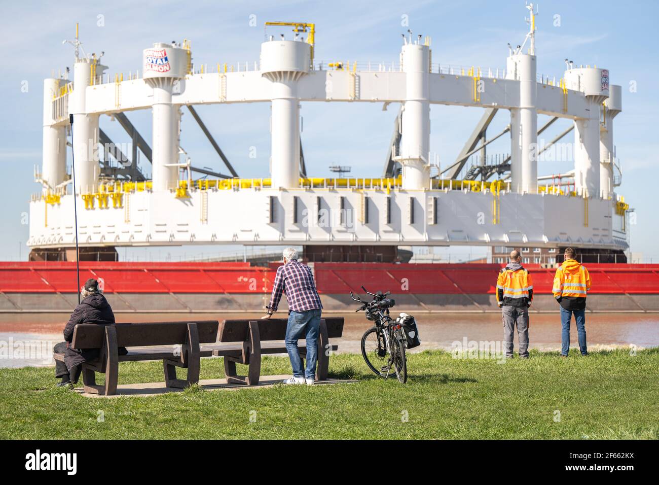 Emden, Germany. 30th Mar, 2021. Onlookers watch as the 1,600-tonne ...