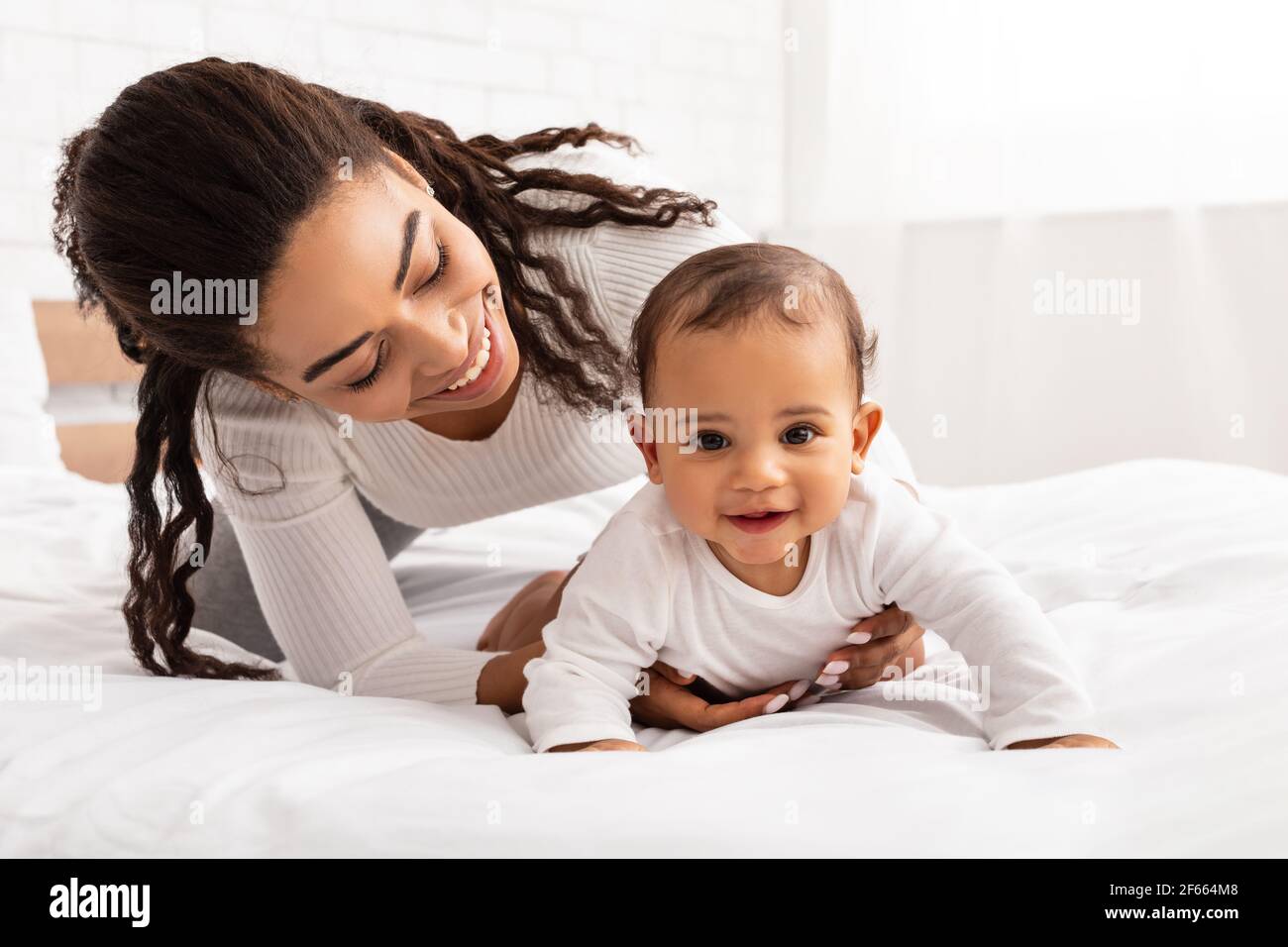 Daughter crawling mother girl woman hi-res stock photography and images ...